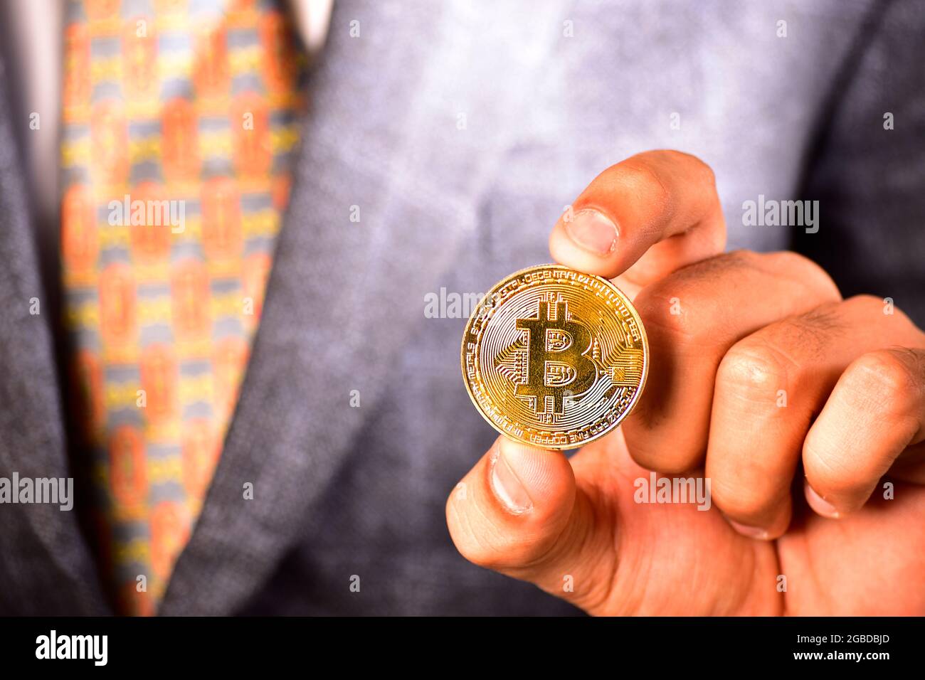 Business In Suit Showing Bitcoin, Bitcoin in Hand Stock Photo - Alamy