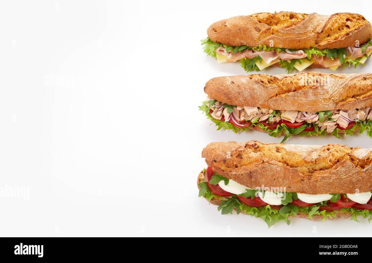 Top view of tasty assorted submarine sandwiches with meat and ...