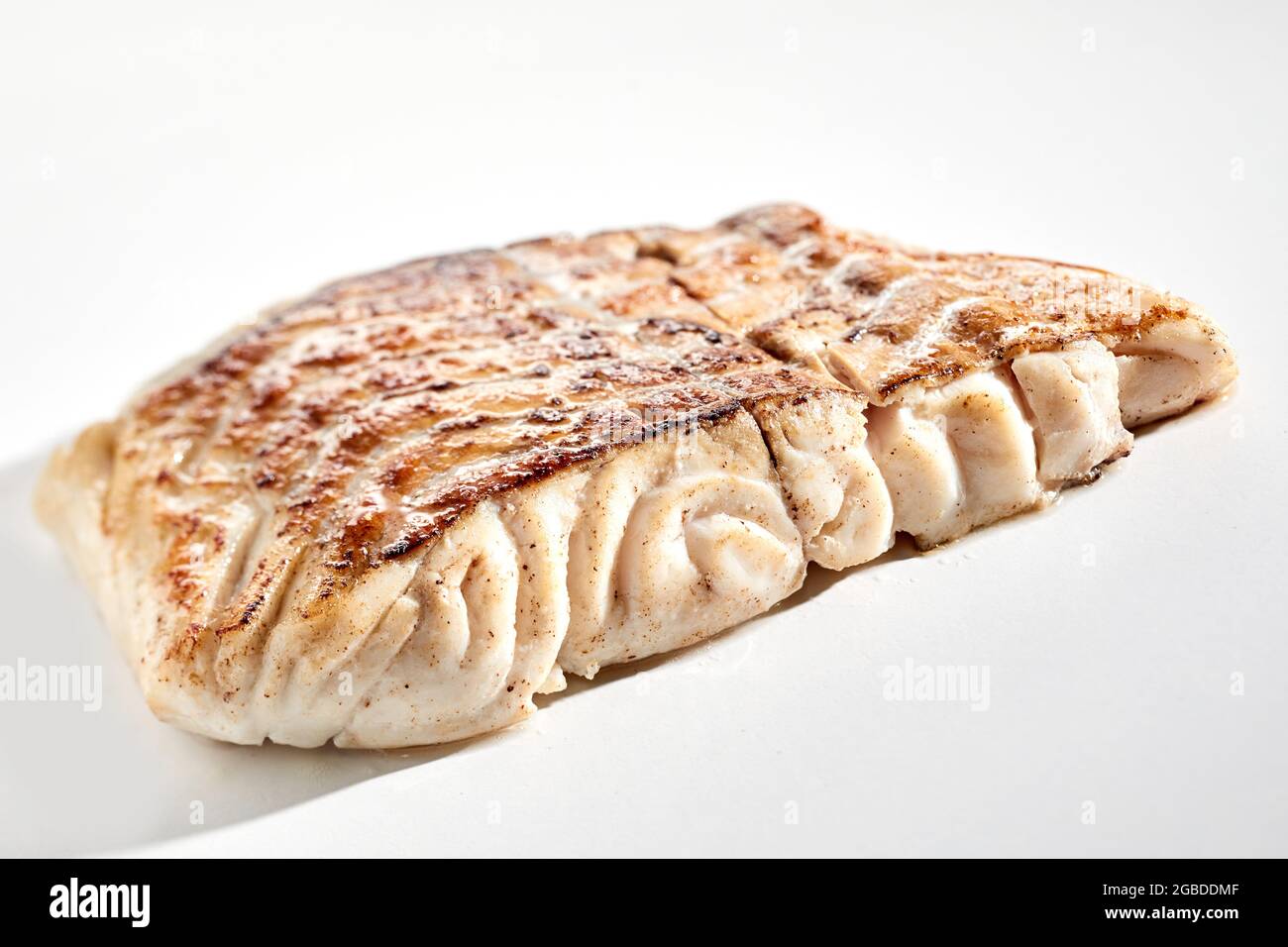 Closeup yummy freshly fried pollack fish steak with crispy crust placed ...