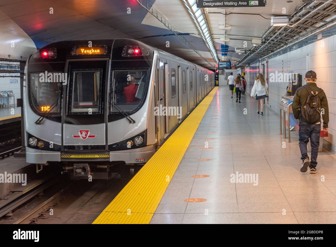 Commuters and TTC Bombardier subway train in Queen Station in Toronto ...