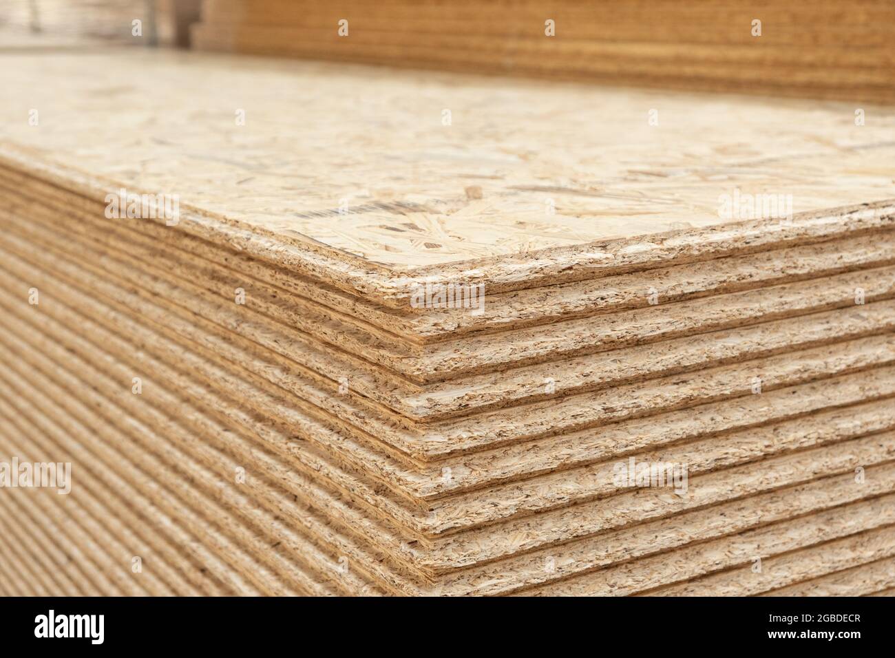 The stack of OSB sheets are stacked in a hardware store on a pallet ...