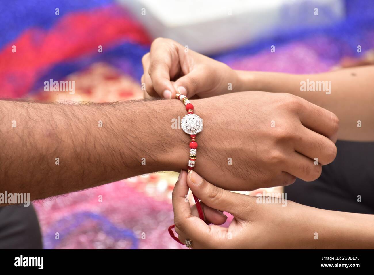 Sister Tying Rakhi On Brother's Hand Stock Photo - Alamy