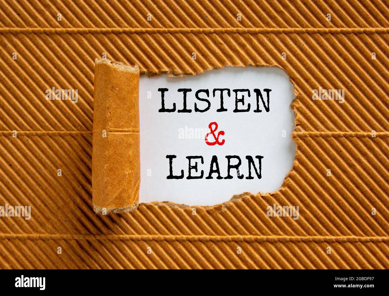 Listen and learn symbol. Words 'Listen and learn' appearing behind torn ...