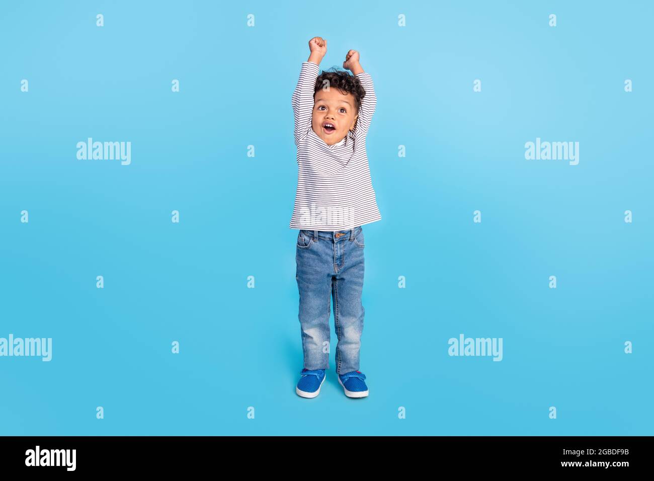 Full length body size view of nice cheerful boy rising hands up ...