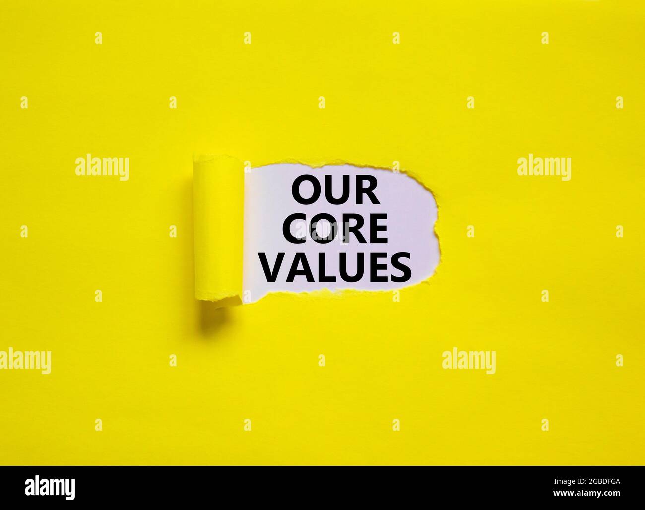Our core values symbol. Words 'Our core values' appearing behind torn ...