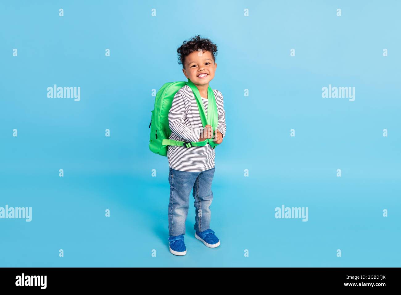 Full length body size view of nice cheerful boy going to first grade ...