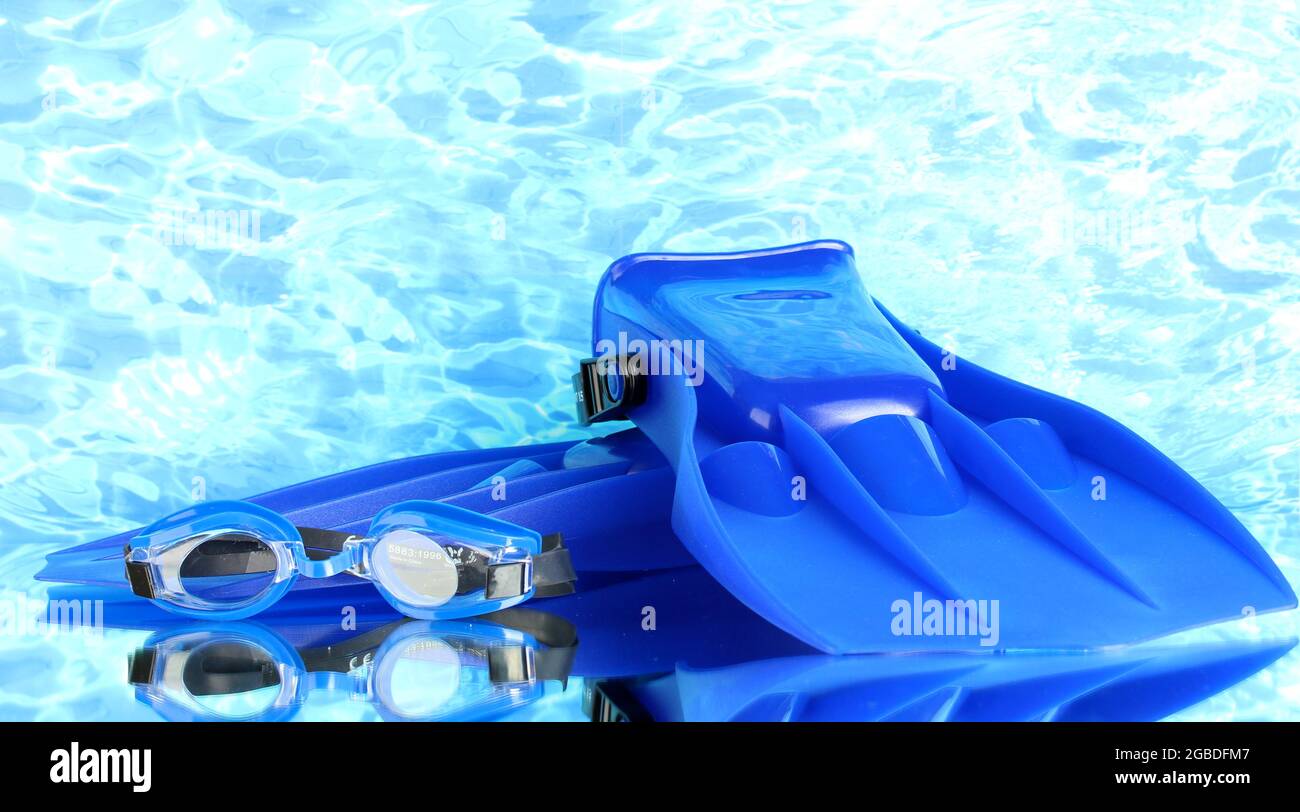 blue flippers and goggles on blue sea background Stock Photo - Alamy
