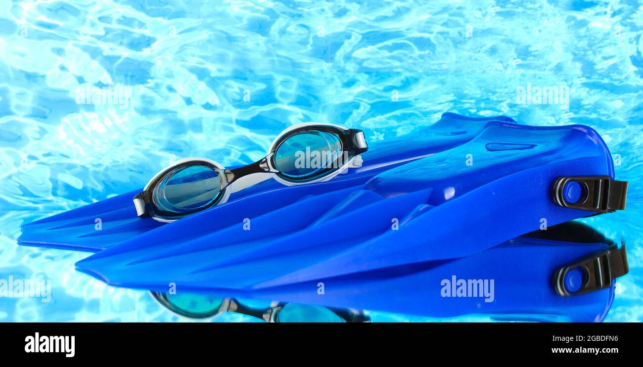 blue flippers and goggles on blue sea background Stock Photo - Alamy
