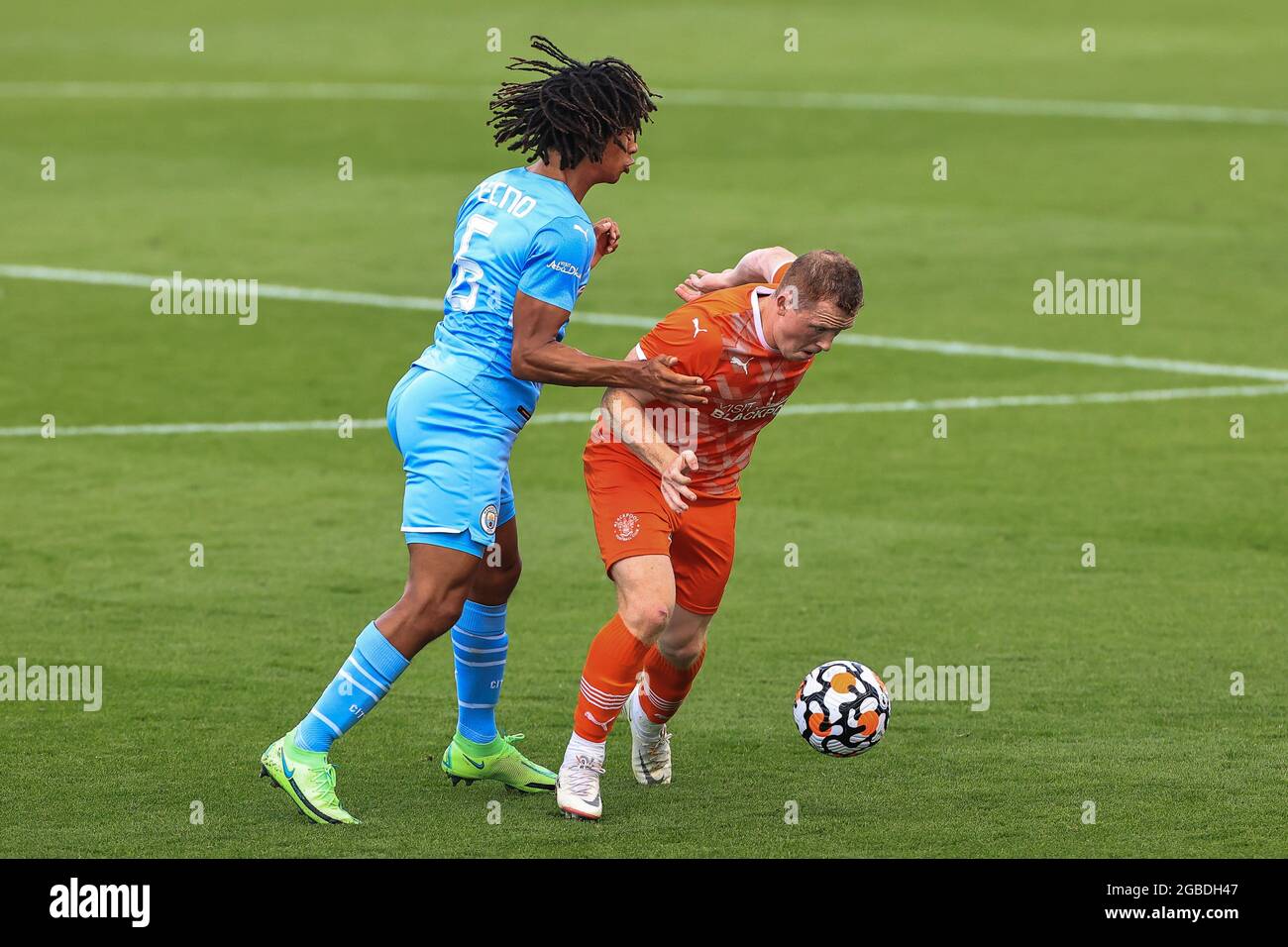 Shayne Lavery of Blackpool controls the ball under pressure from Nathan ...