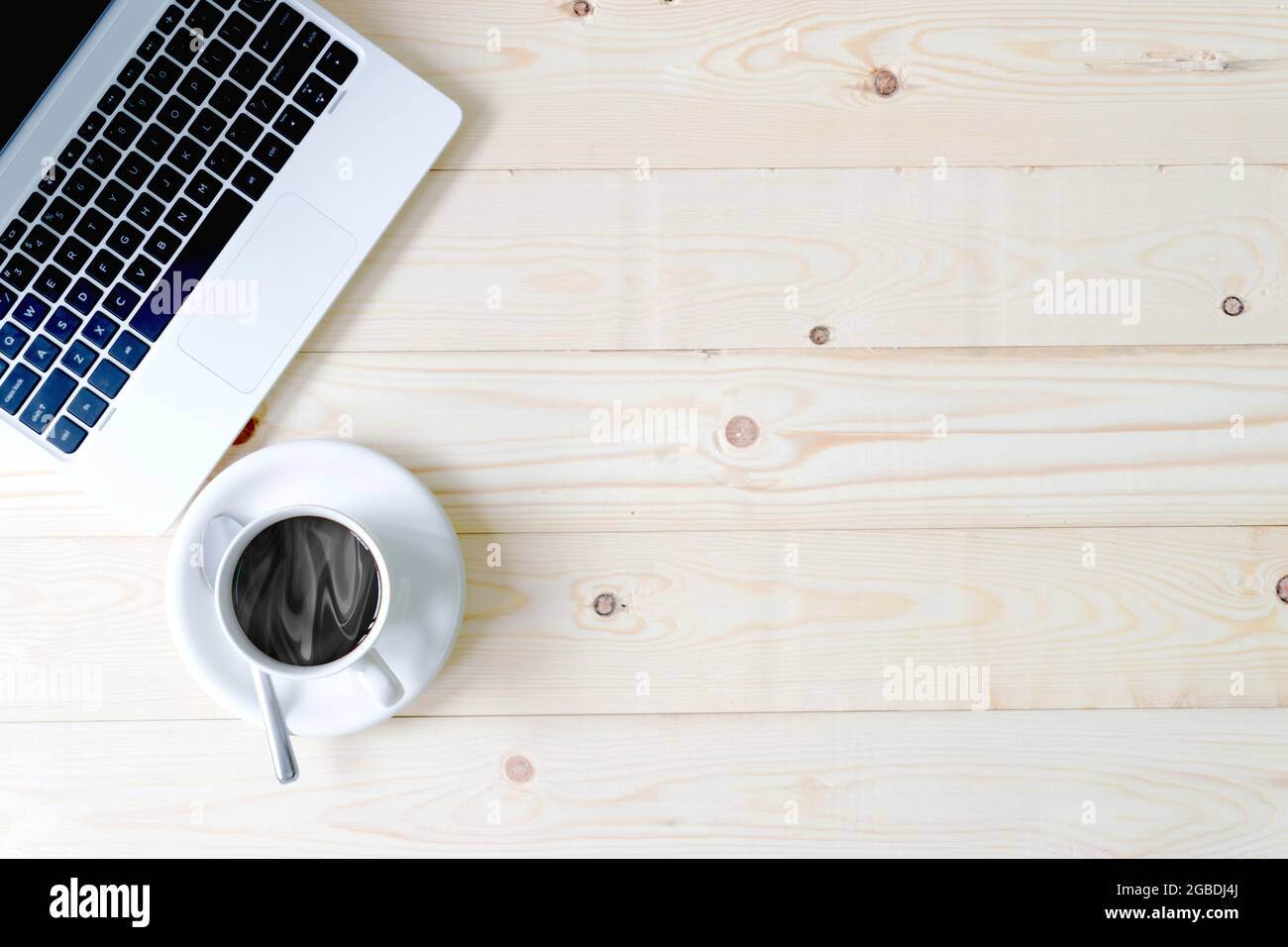 Keyboard of an open notebook, cup of coffee Stock Photo - Alamy