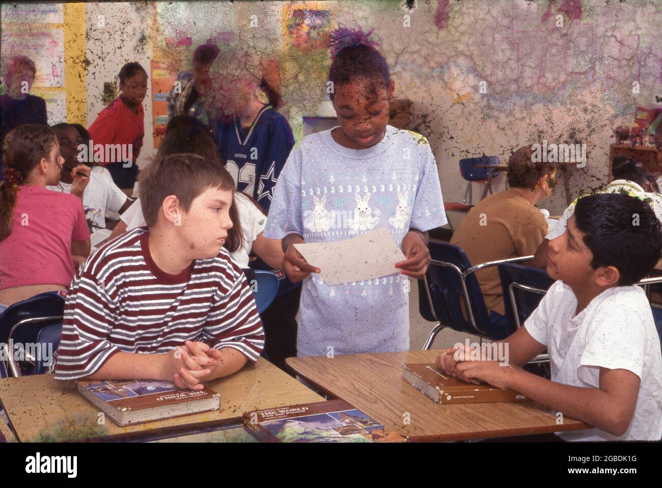 Middle school class breaking into small groups for work Stock Photo - Alamy