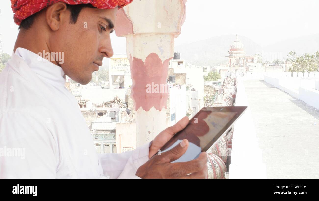 Indian man in traditional clothing using a tablet Stock Photo - Alamy