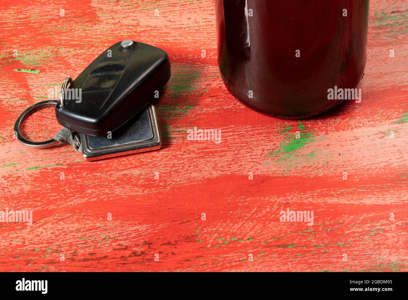 alcohol abuse and danger in car driving symbolized by key and bottle ...