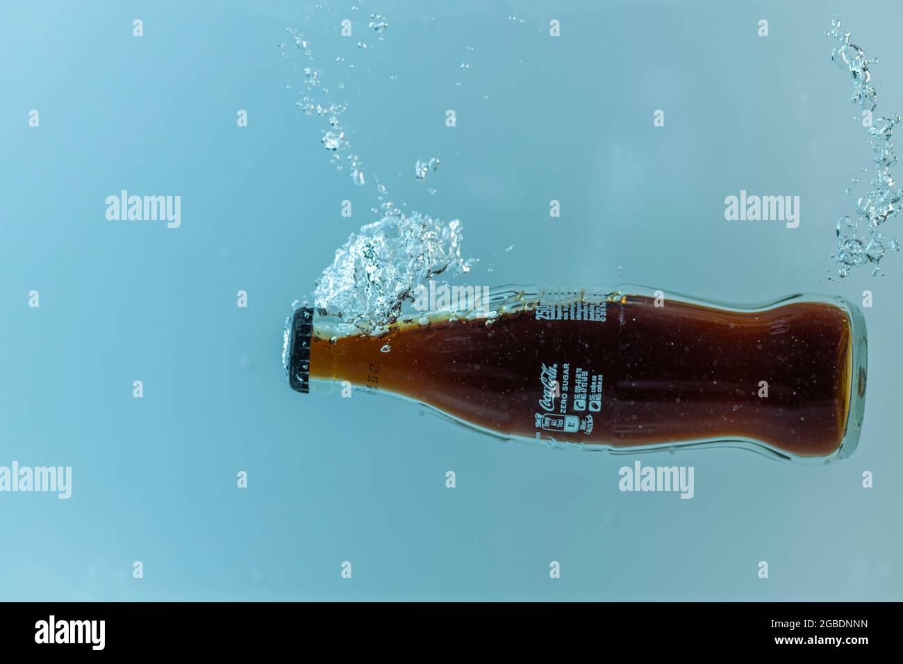 Close up view of Coca cola bottle falling in water Stock Photo - Alamy