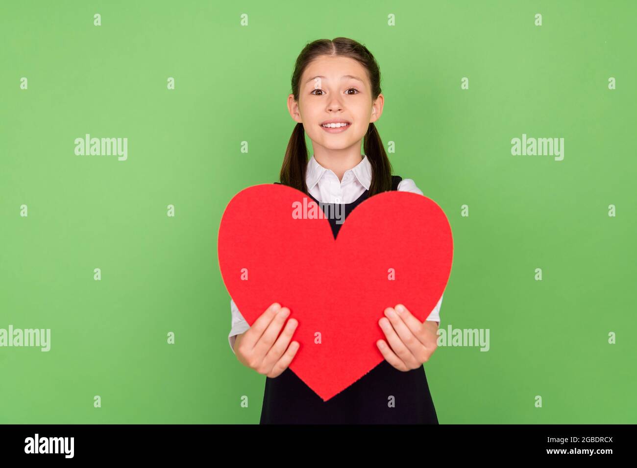 Photo portrait little girl cute cheerful keeping red paper heart ...