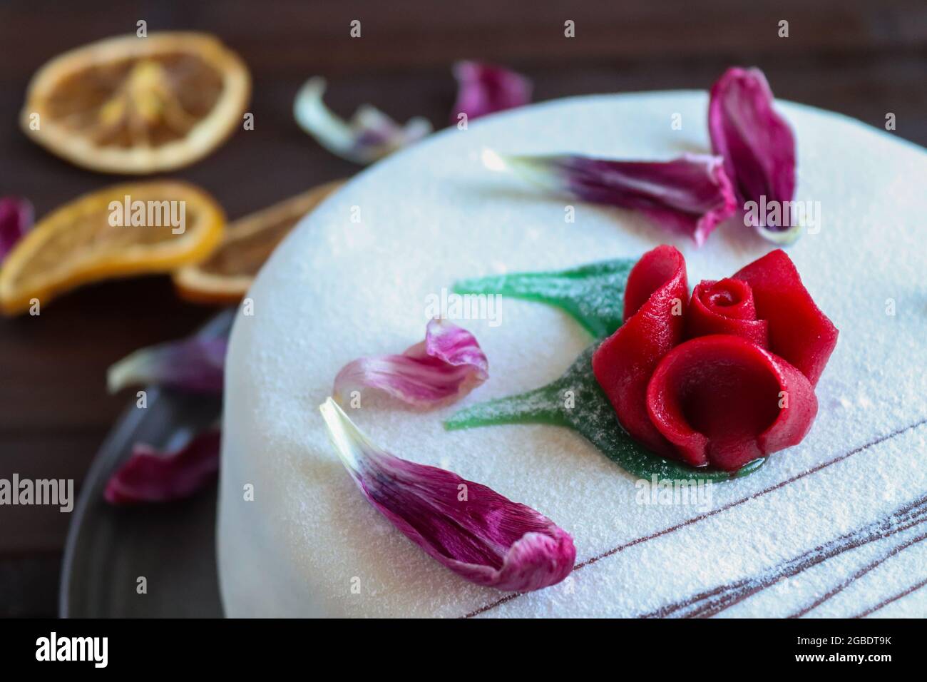 White cake decorated with rose and dry petals Stock Photo - Alamy