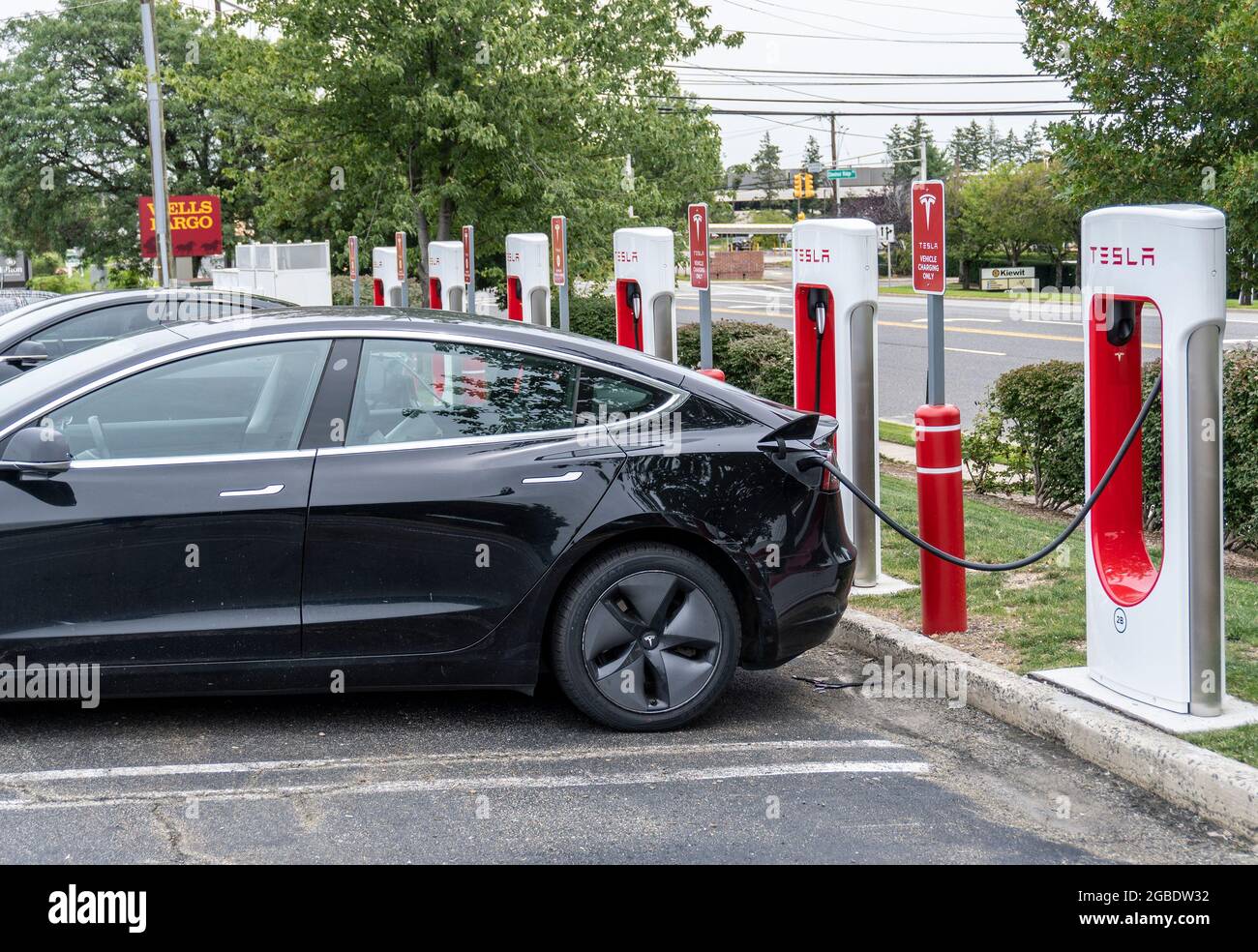 A Tesla electric car at a mall charging station Stock Photo - Alamy