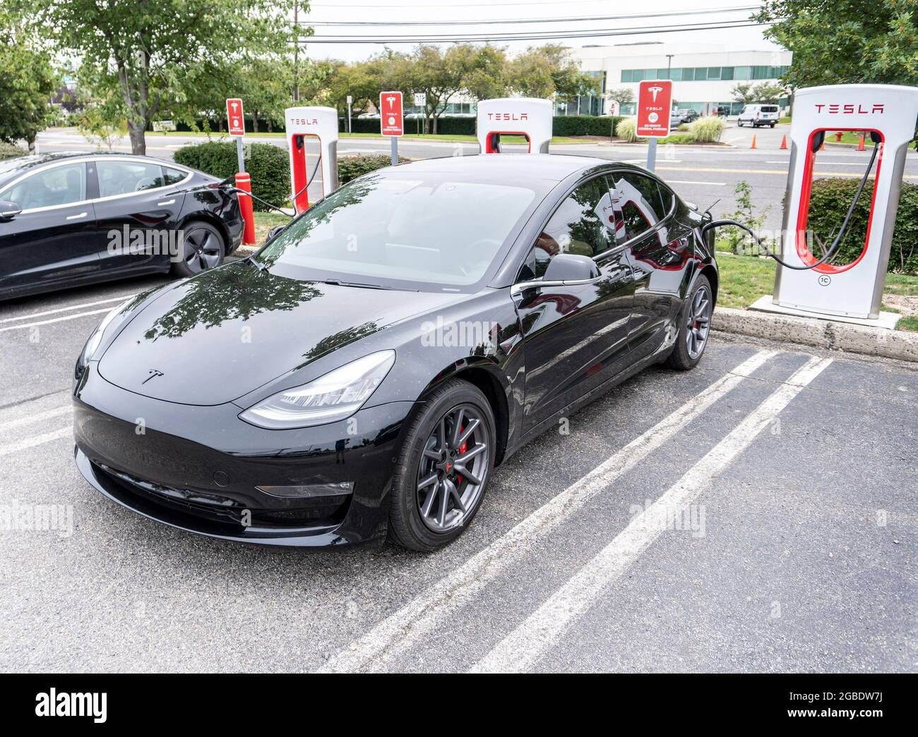 A Tesla electric car at a mall charging station Stock Photo - Alamy