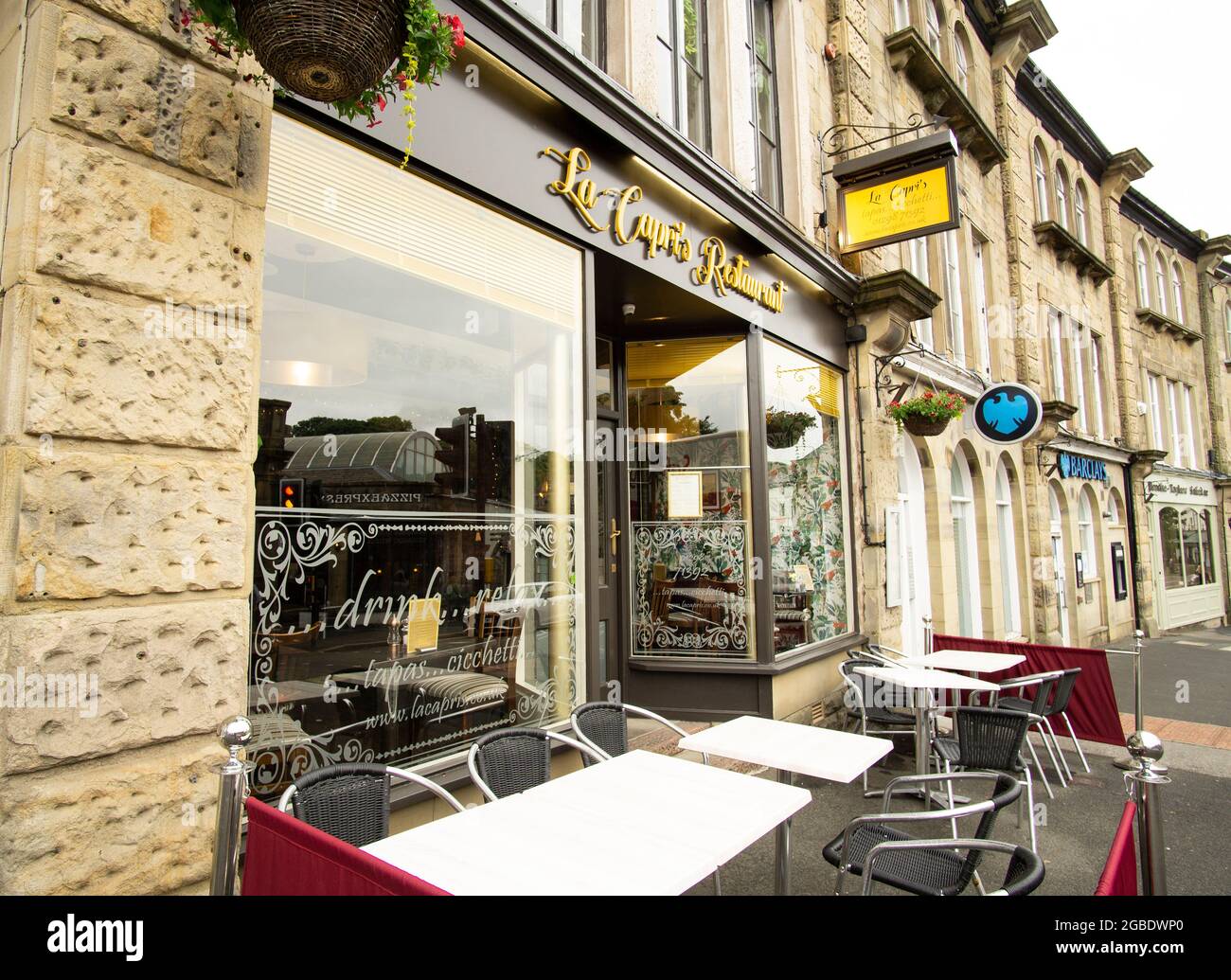 Seating outside a high street restaurant Stock Photo - Alamy