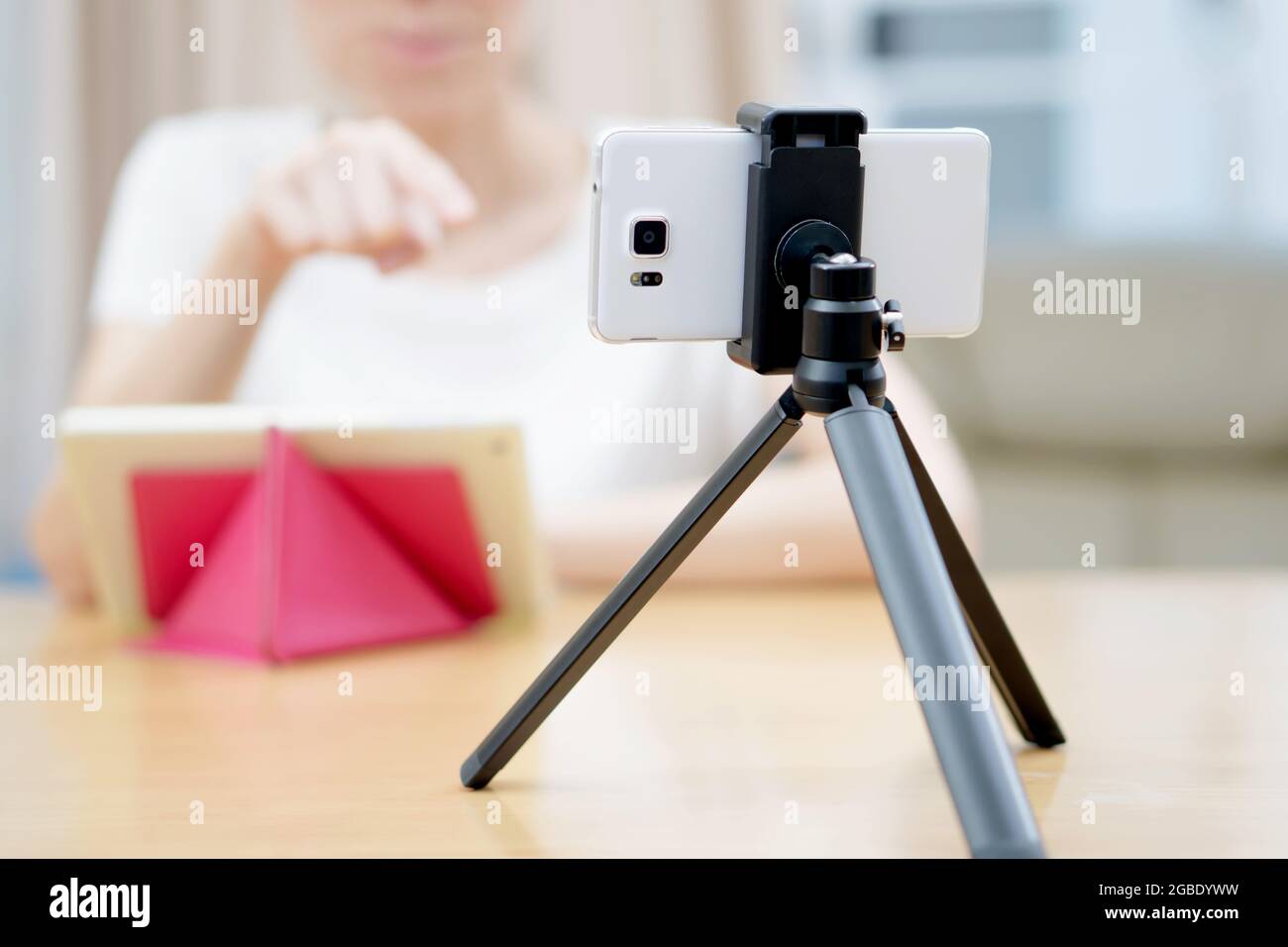 Woman vlogger looking using ipad computer and filming on video her life ...