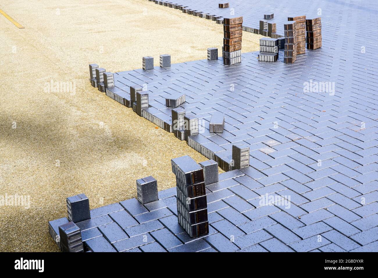 laying of modern beautiful design cobblestones on a flat prepared ...