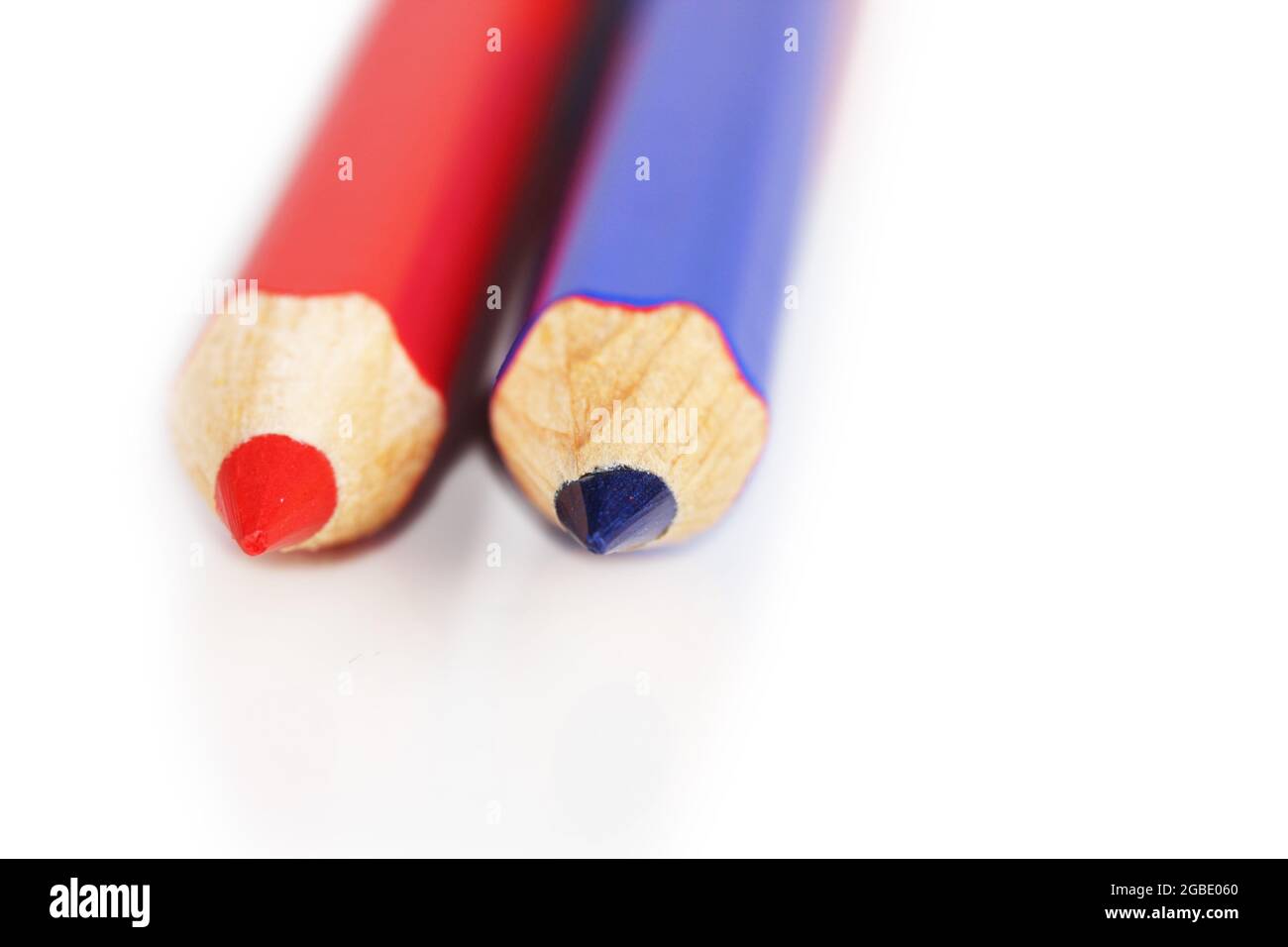 Red and blue pencils close-up isolated on white Stock Photo - Alamy