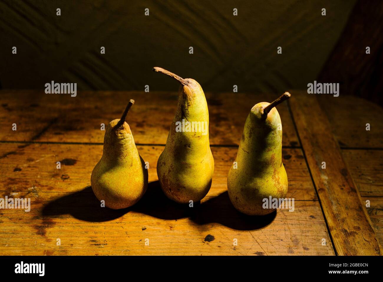 Close up of three European pear standing on a grunge wooden table Stock ...
