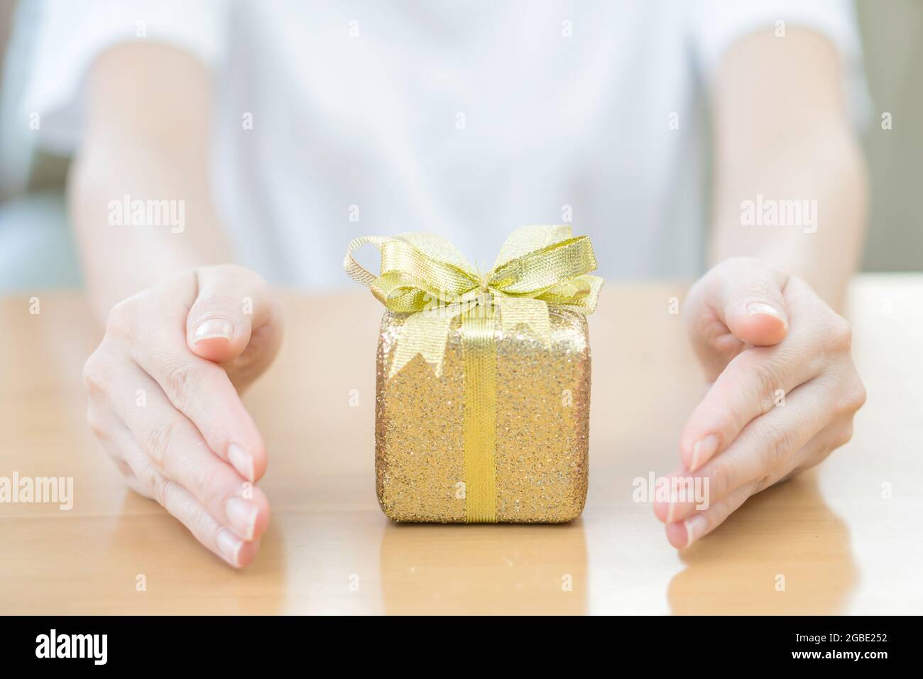 Woman hand holding gift box Stock Photo - Alamy