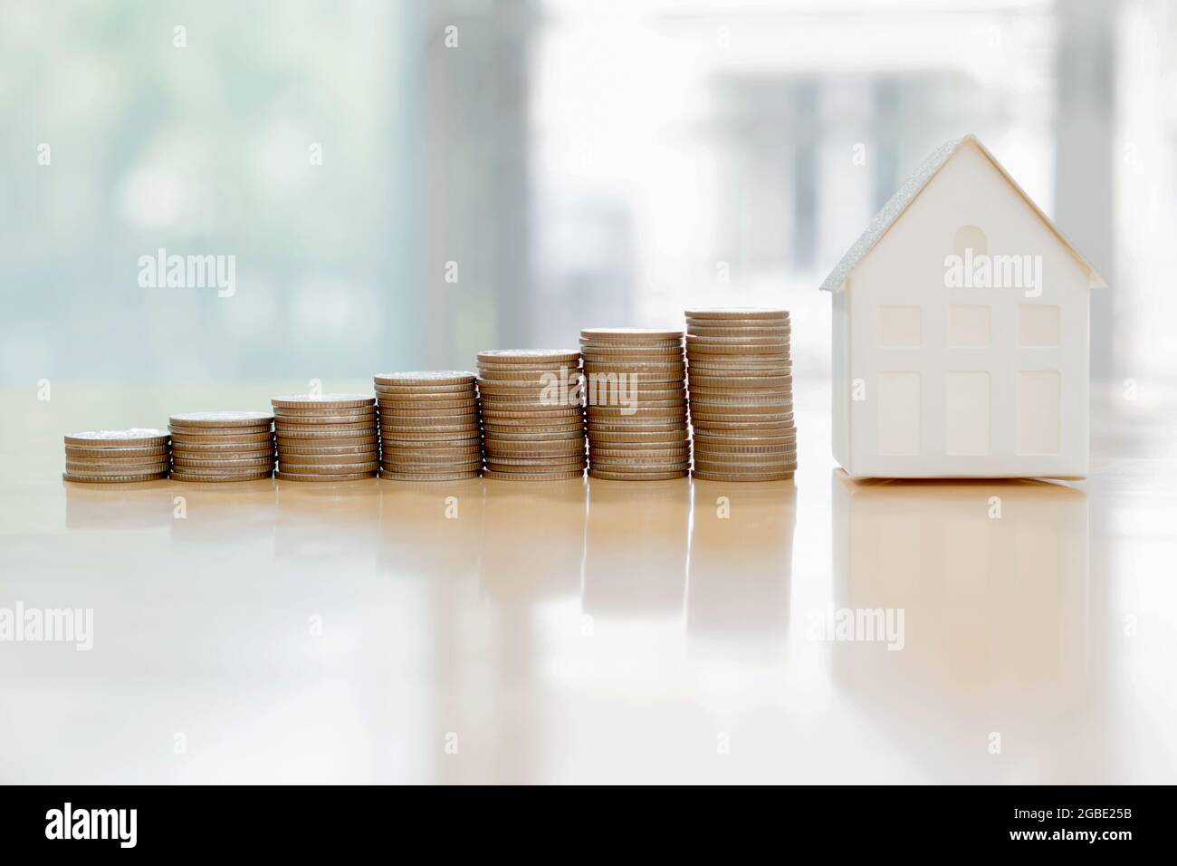 House model and coin money,mortgage and real estate investment Stock ...