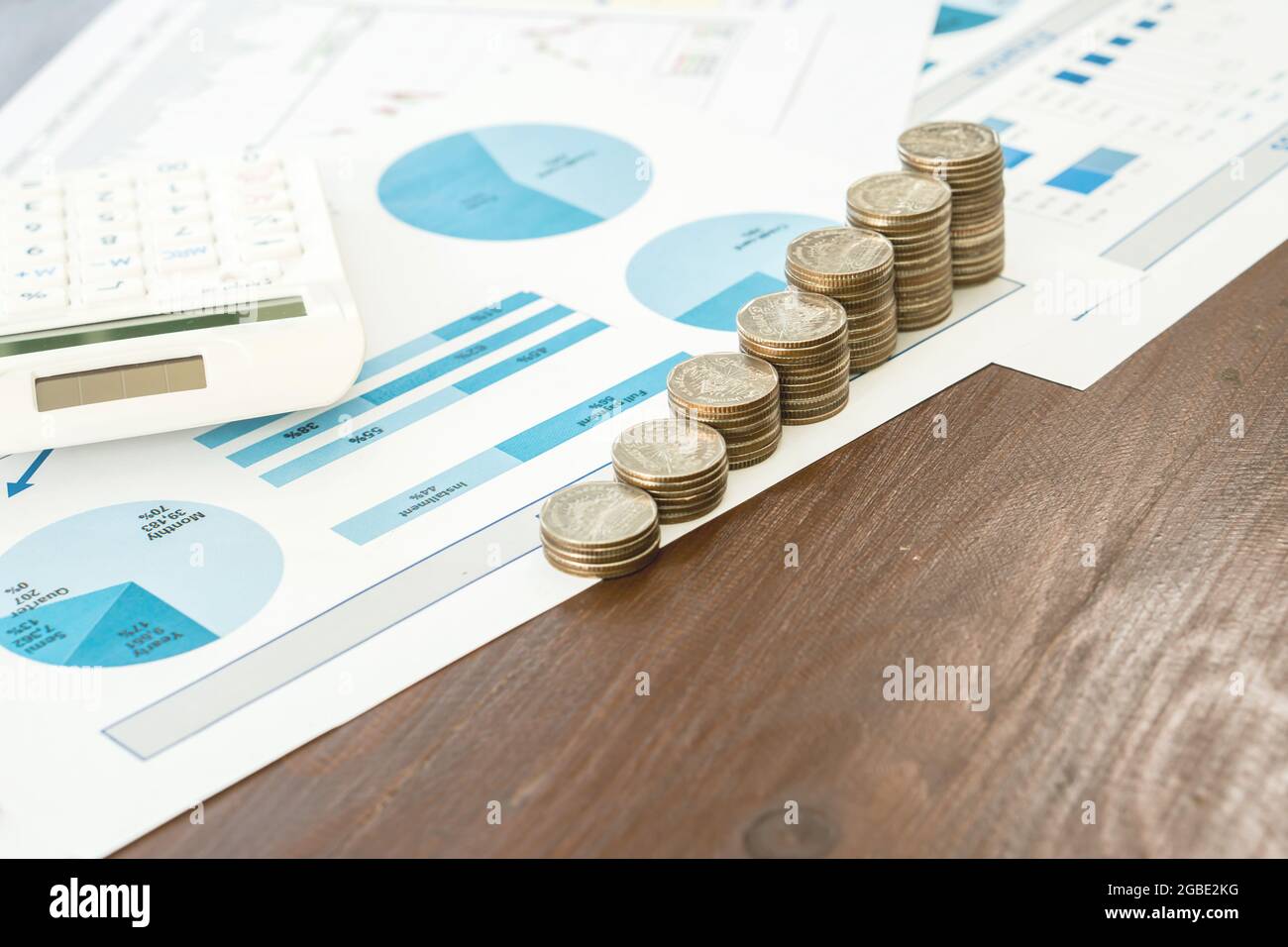 Graph with calculator and coins Stock Photo - Alamy