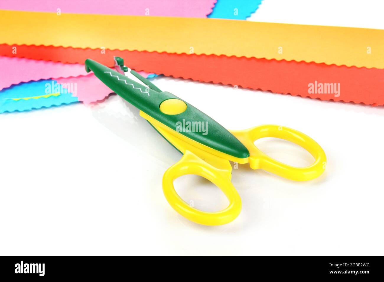 Colorful zigzag scissors with color paper isolated on white Stock Photo ...