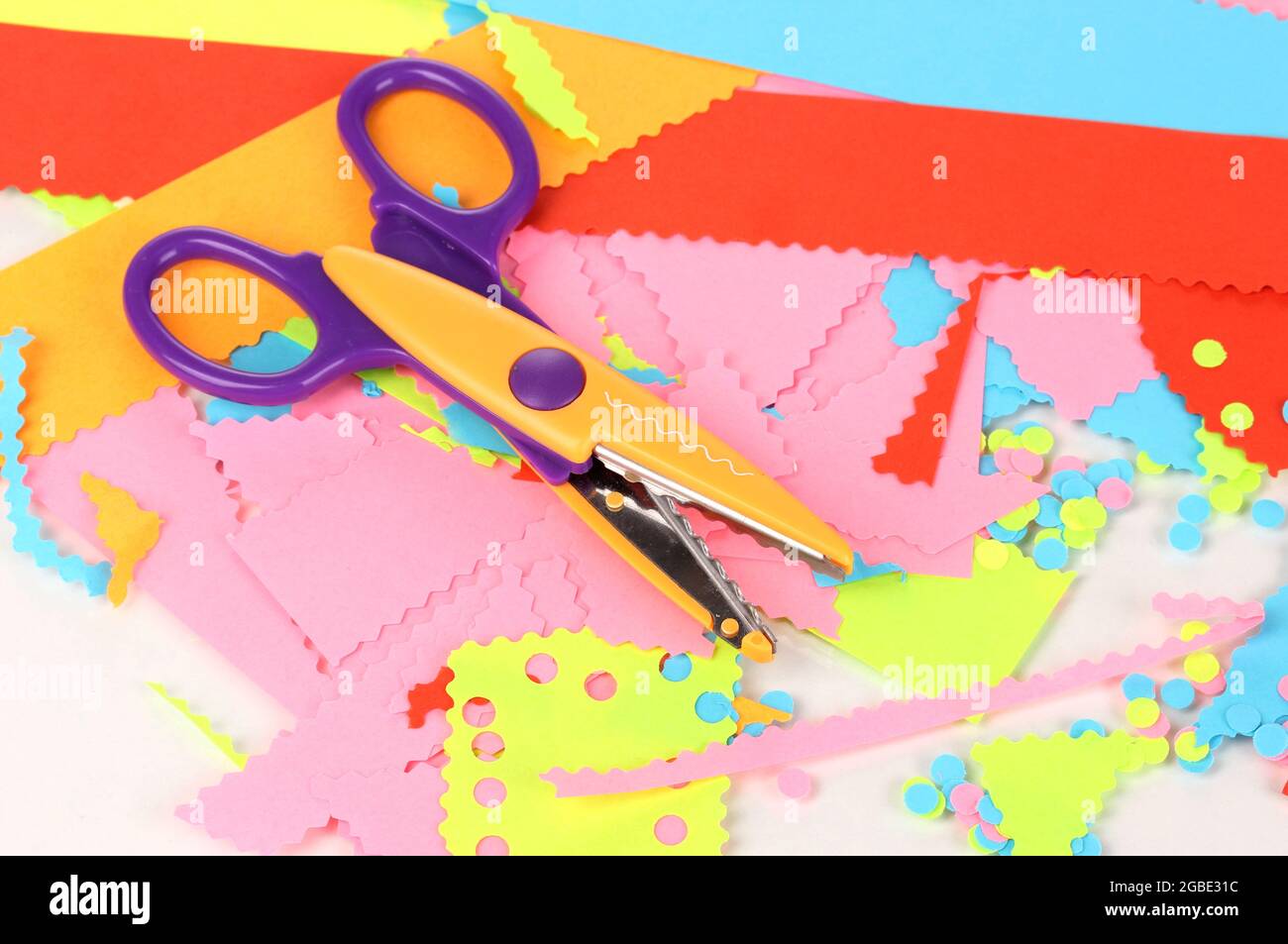 Colorful zigzag scissors with color paper isolated on white Stock Photo ...
