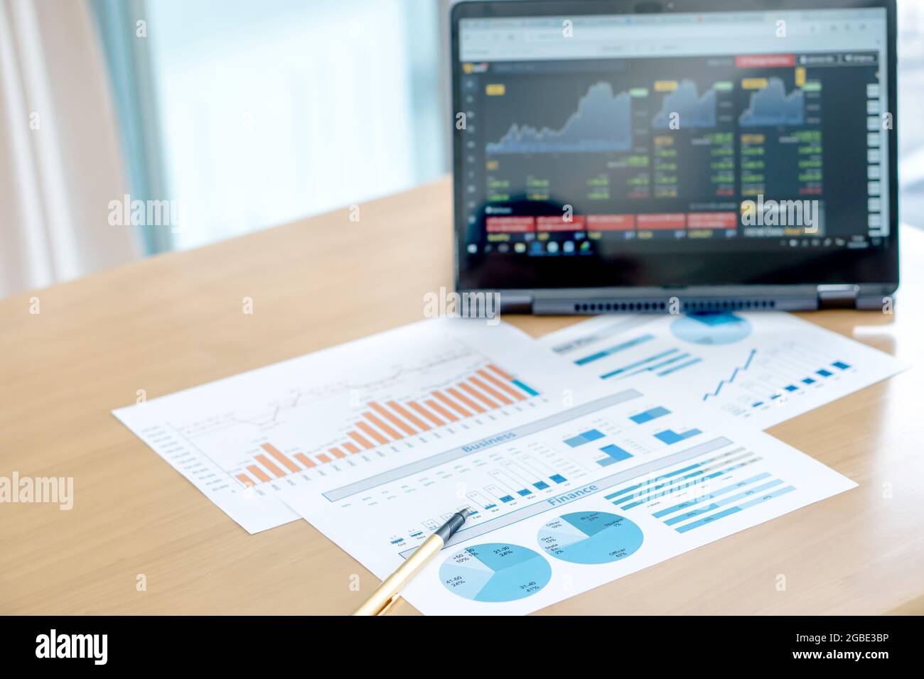 Business workplace with laptop, graph, pen Stock Photo - Alamy