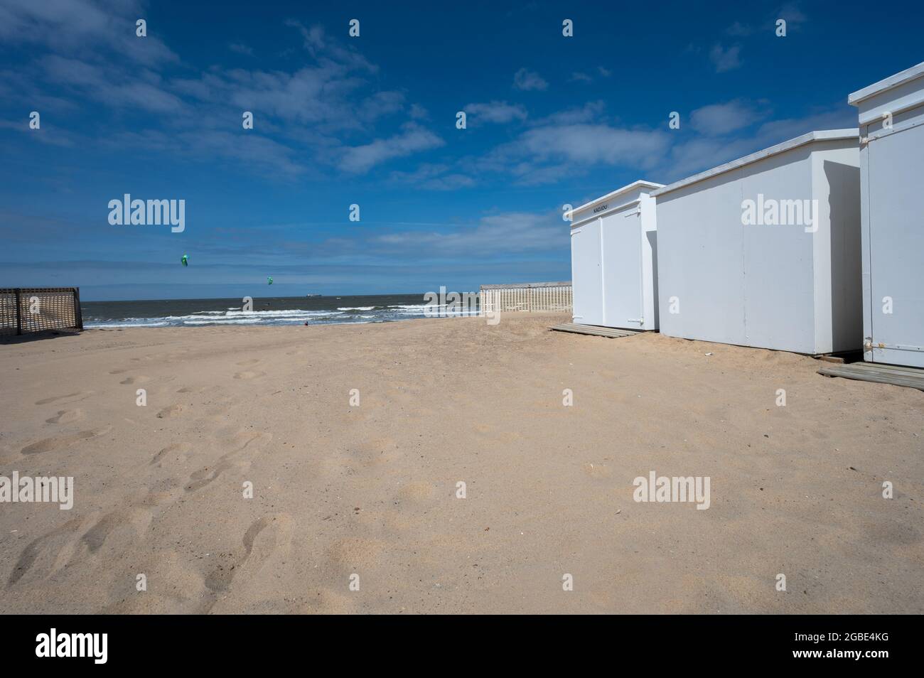White beach huts on yellow sandy beaches in small Belgian town Knokke ...