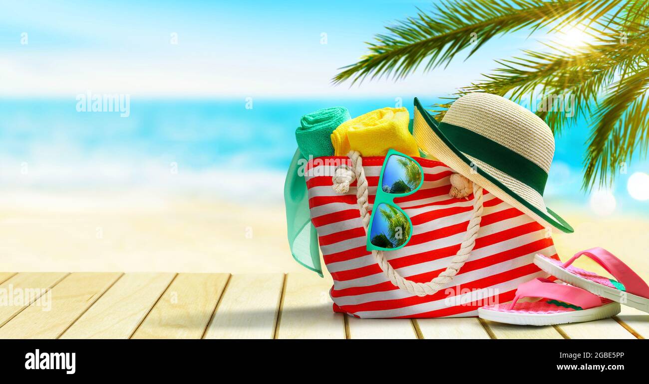Beach bag, flip flops, hat and sunglasses on a tropical beach Stock ...