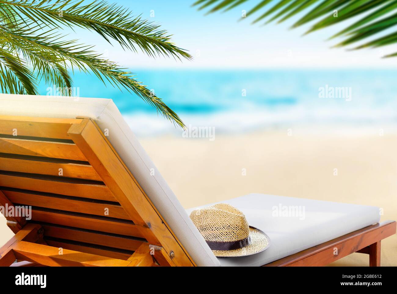 Beach lounger with straw hat on the beach. Travel vacation concept ...