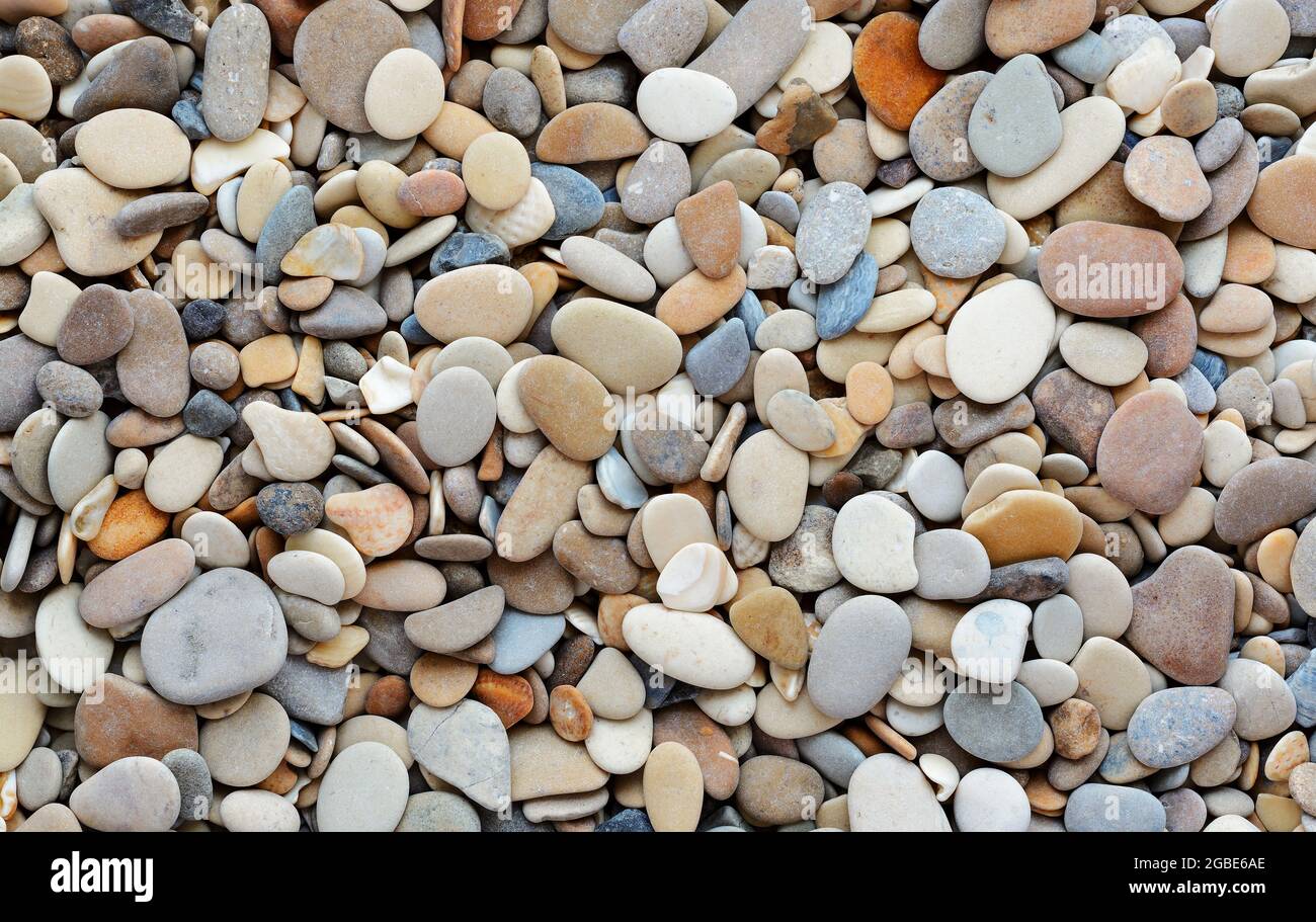 Pebbles on the beach texture or background Stock Photo - Alamy
