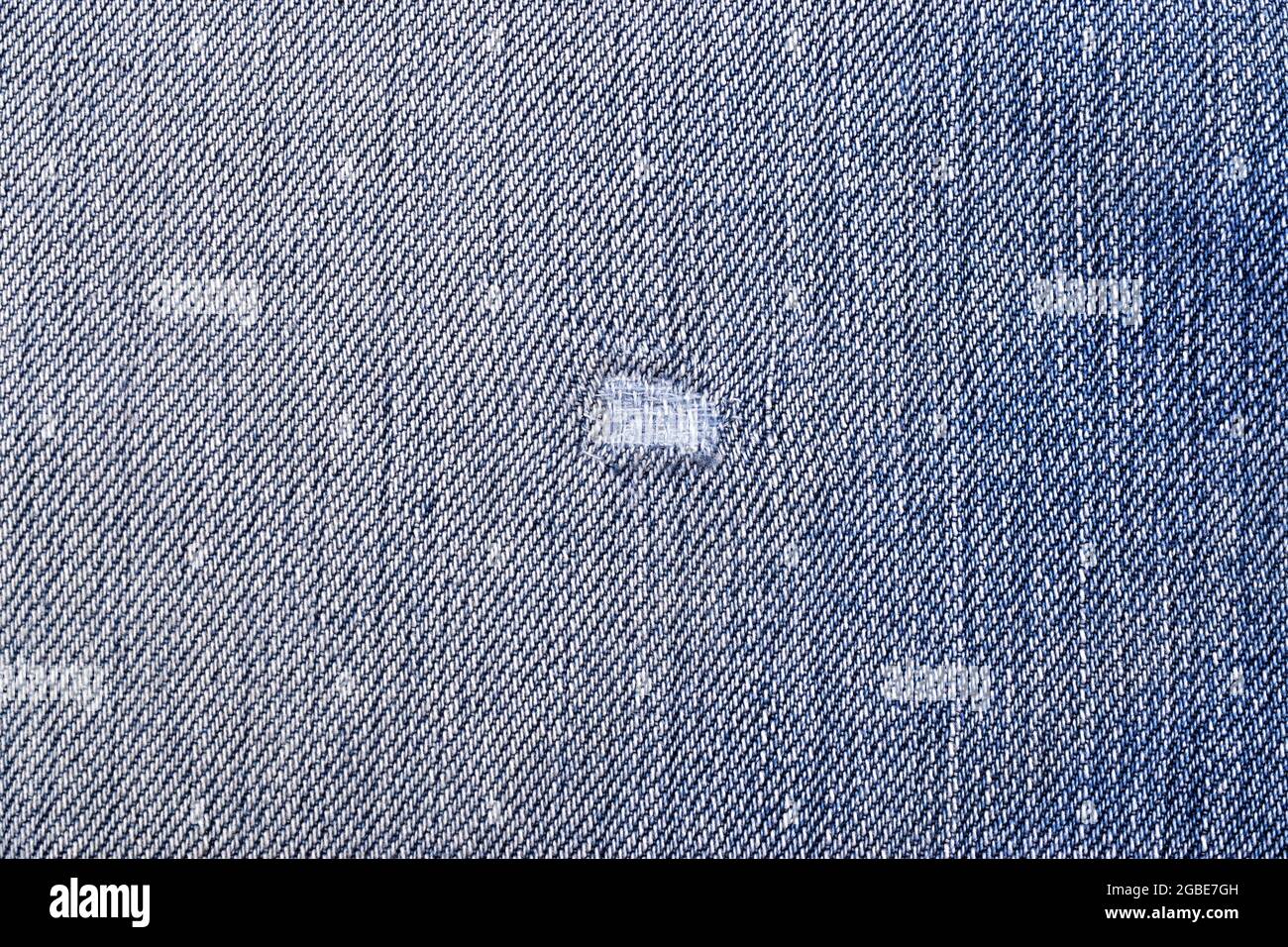 Tiny Ripped Patch on Denim Cloth Stock Photo - Alamy