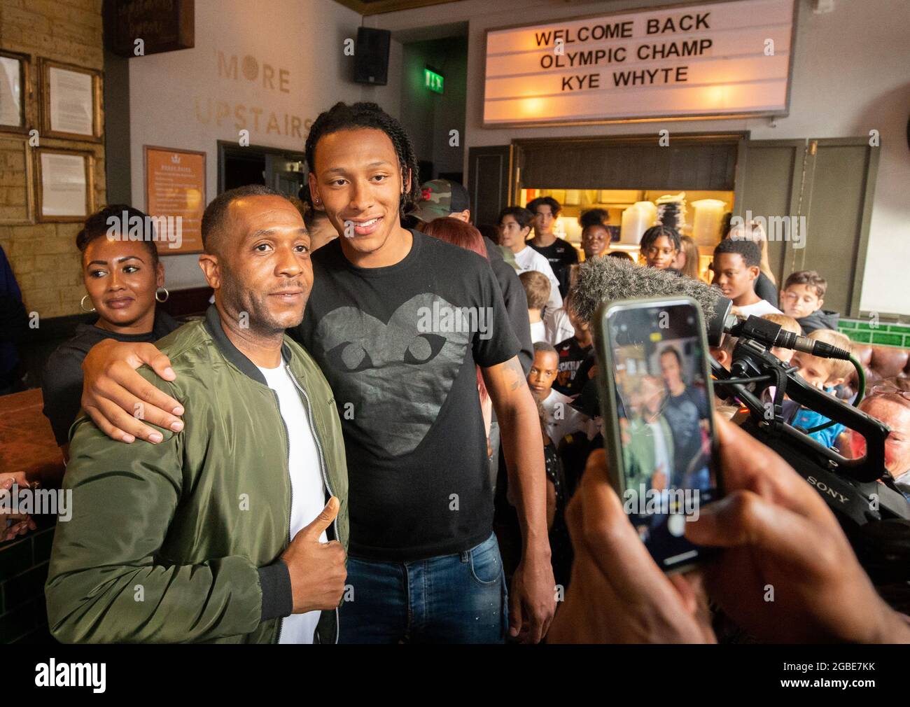 Silver medallist BMXer Kye Whyte (right) has his photo taken at a ...