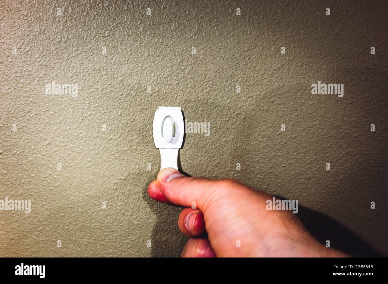 Selective focus on adhesive strip wall hanger that can be removed by ...
