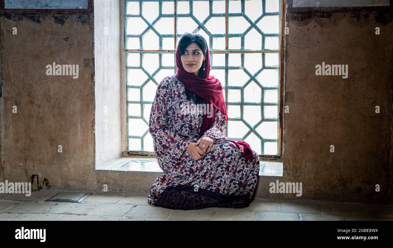 Isfahan, Iran - May 2019: Iranian woman sitting by a windows inside Ali ...