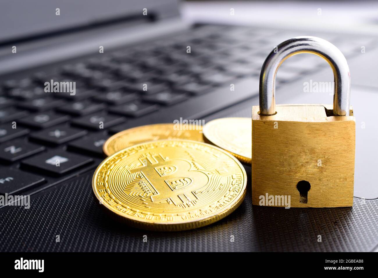 bitcoin security concept. Gold coin with padlock on laptop Stock Photo ...