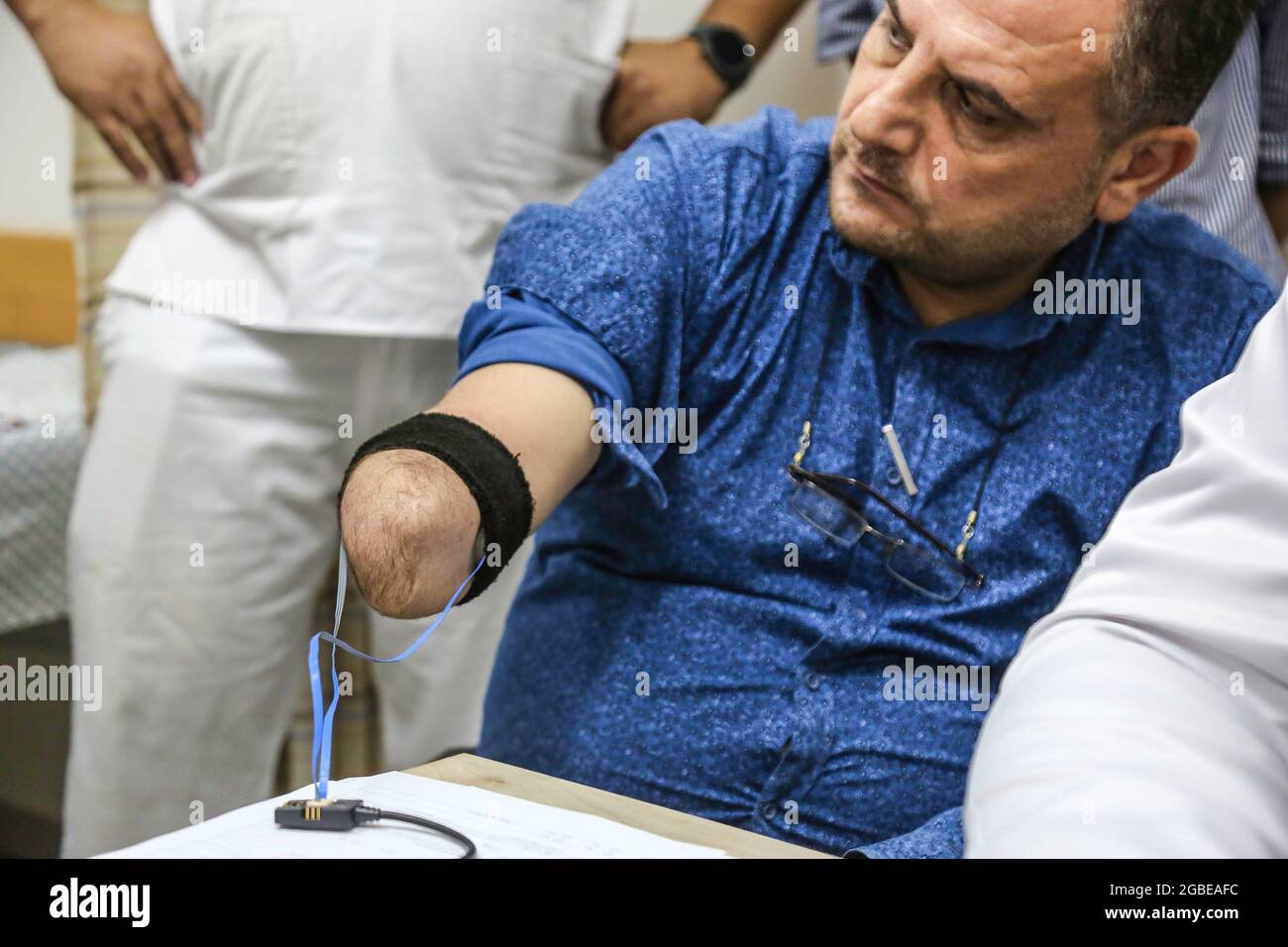 Gaza, Palestine. 03rd Aug, 2021. A Palestinian doctor checks the hand ...