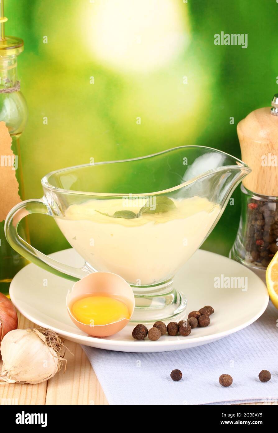 Mayonnaise in bowl close-up on wooden table on nature background Stock ...
