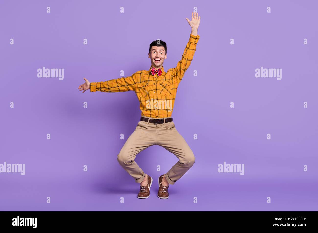 Photo of adorable funny young guy dressed checkered shirt dancing ...
