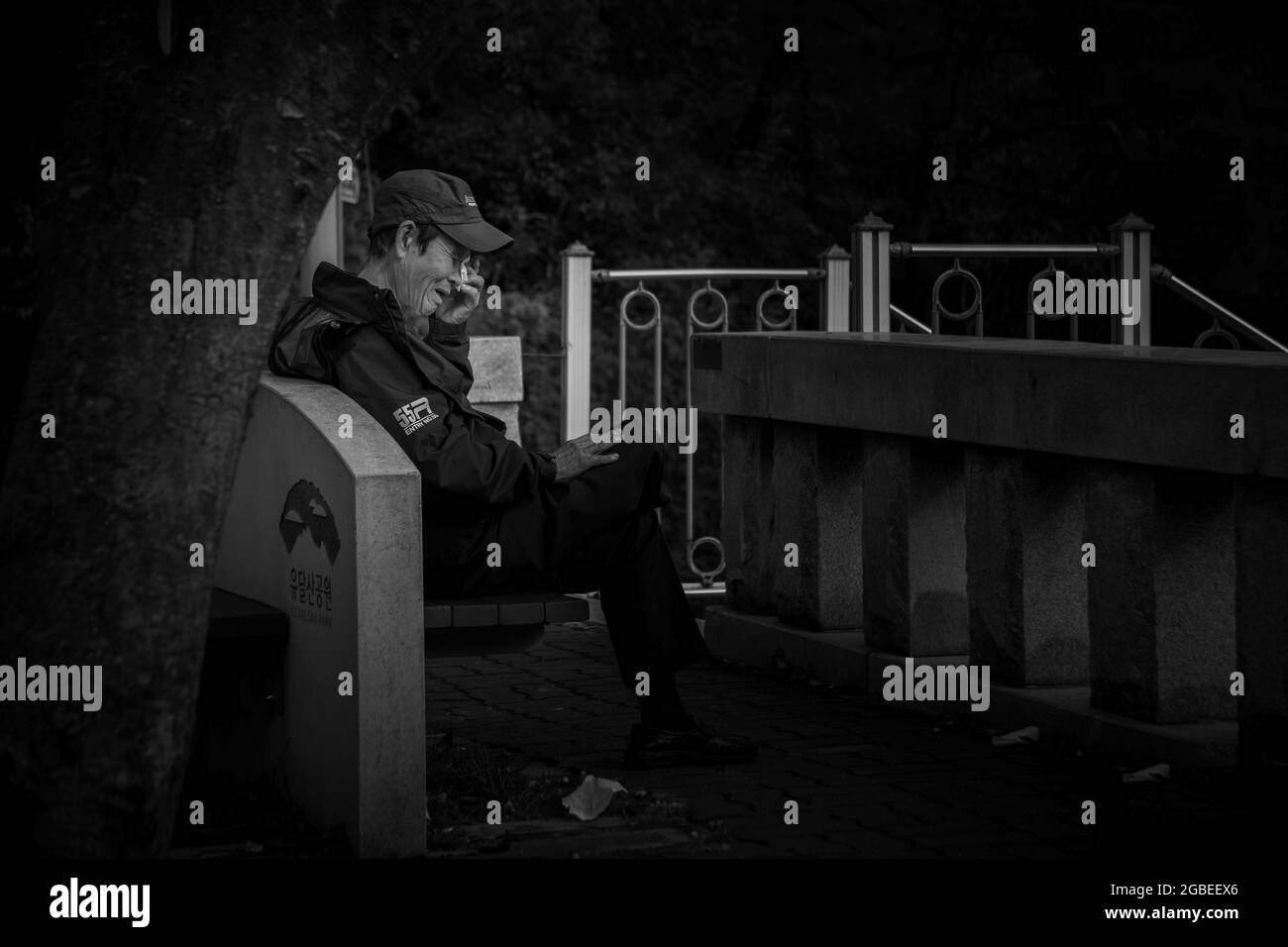 MOKPO, KOREA, SOUTH - Mar 05, 2015: A grayscale shot of an elderly ...