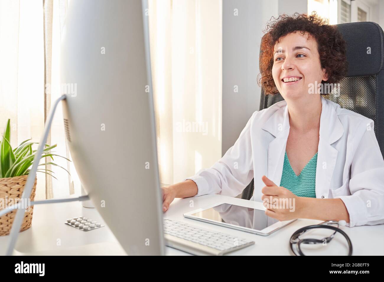 A female doctor uses her computer in her medical office Stock Photo - Alamy