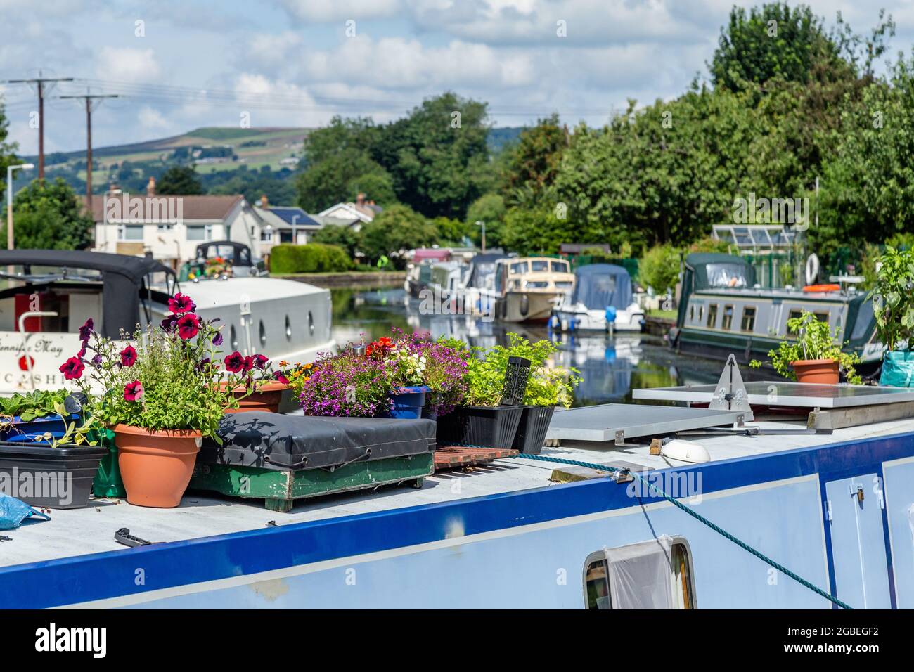 Flower pots on top of a barge on the Leeds Liverpool Canal at Bingley ...
