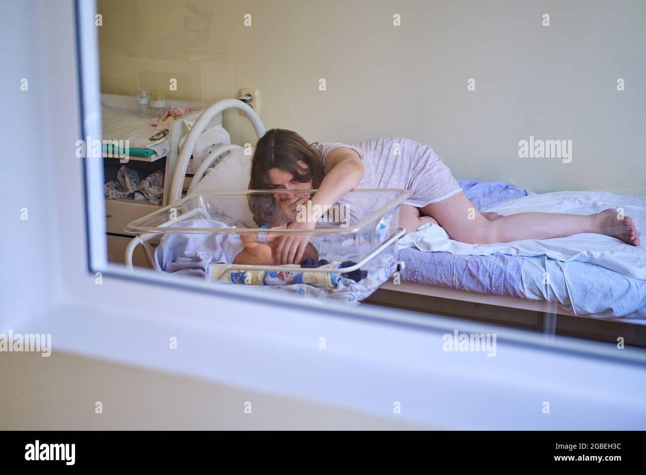 Mom is in the ward with a newborn baby, a maternity hospital bracelet ...