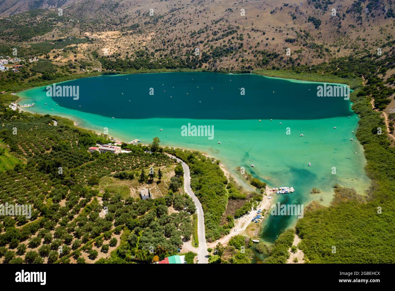 Aerial view of a huge freshwater lake surrounded by tall mountains ...